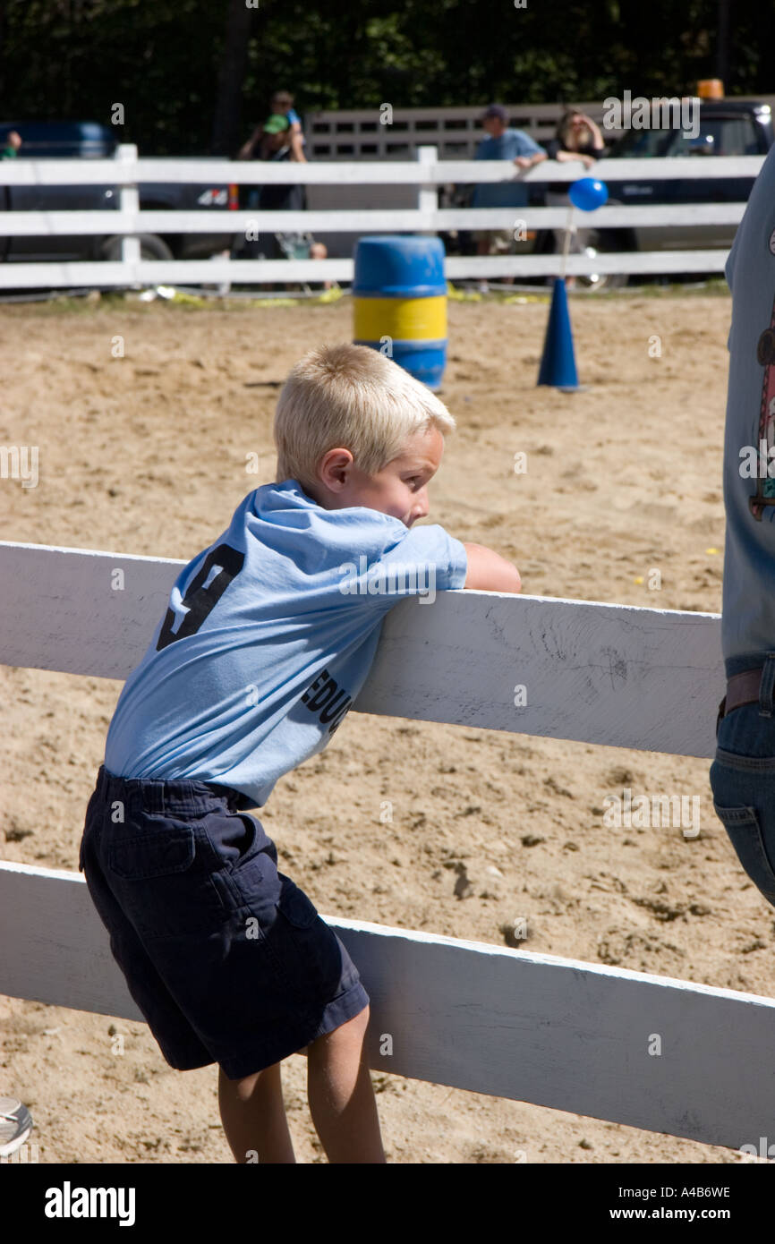 Boy watching Barrel racing at the county fair Stock Photo - Alamy