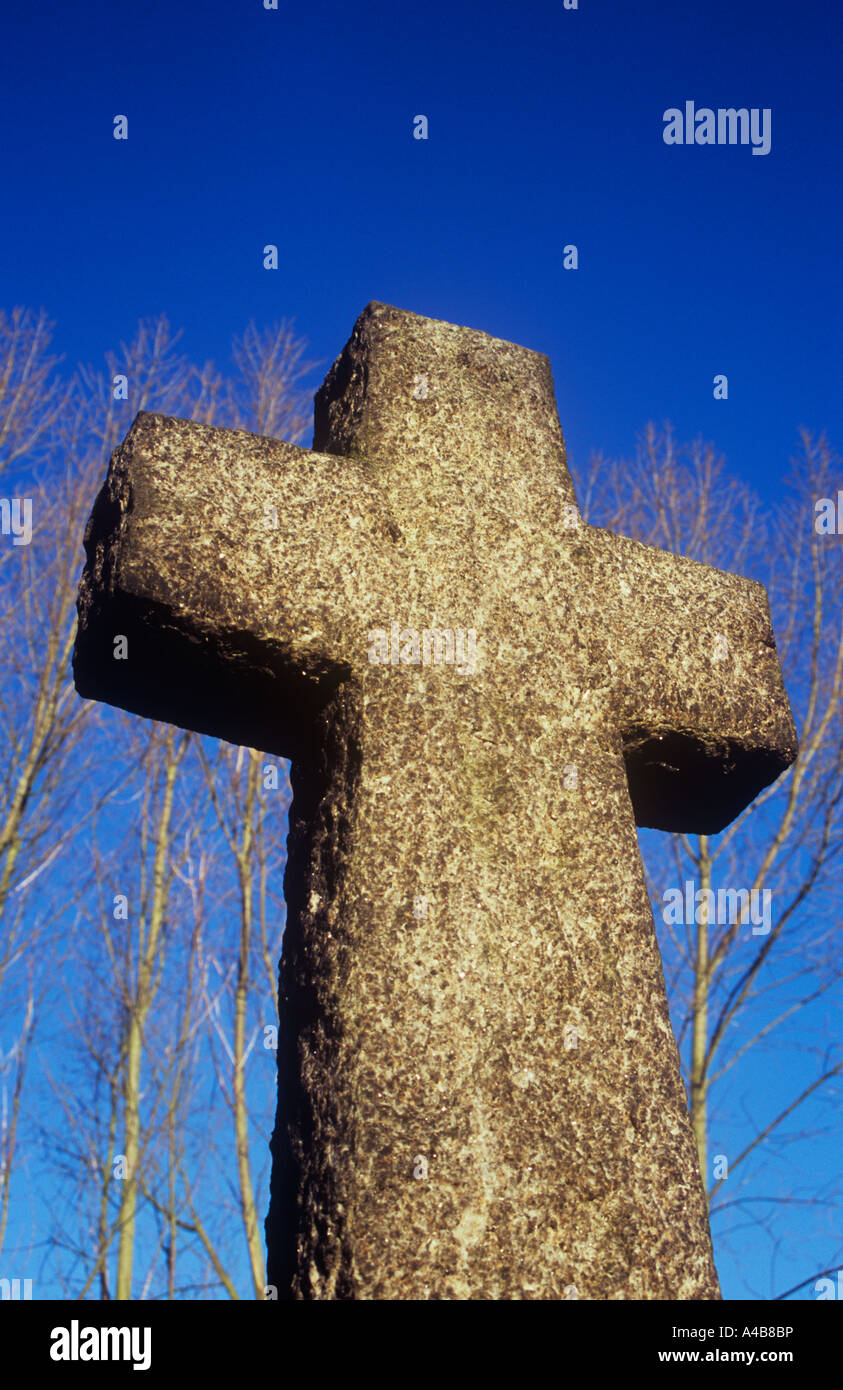 View from below of large rough-hewn stone crucifix in warm winter ...