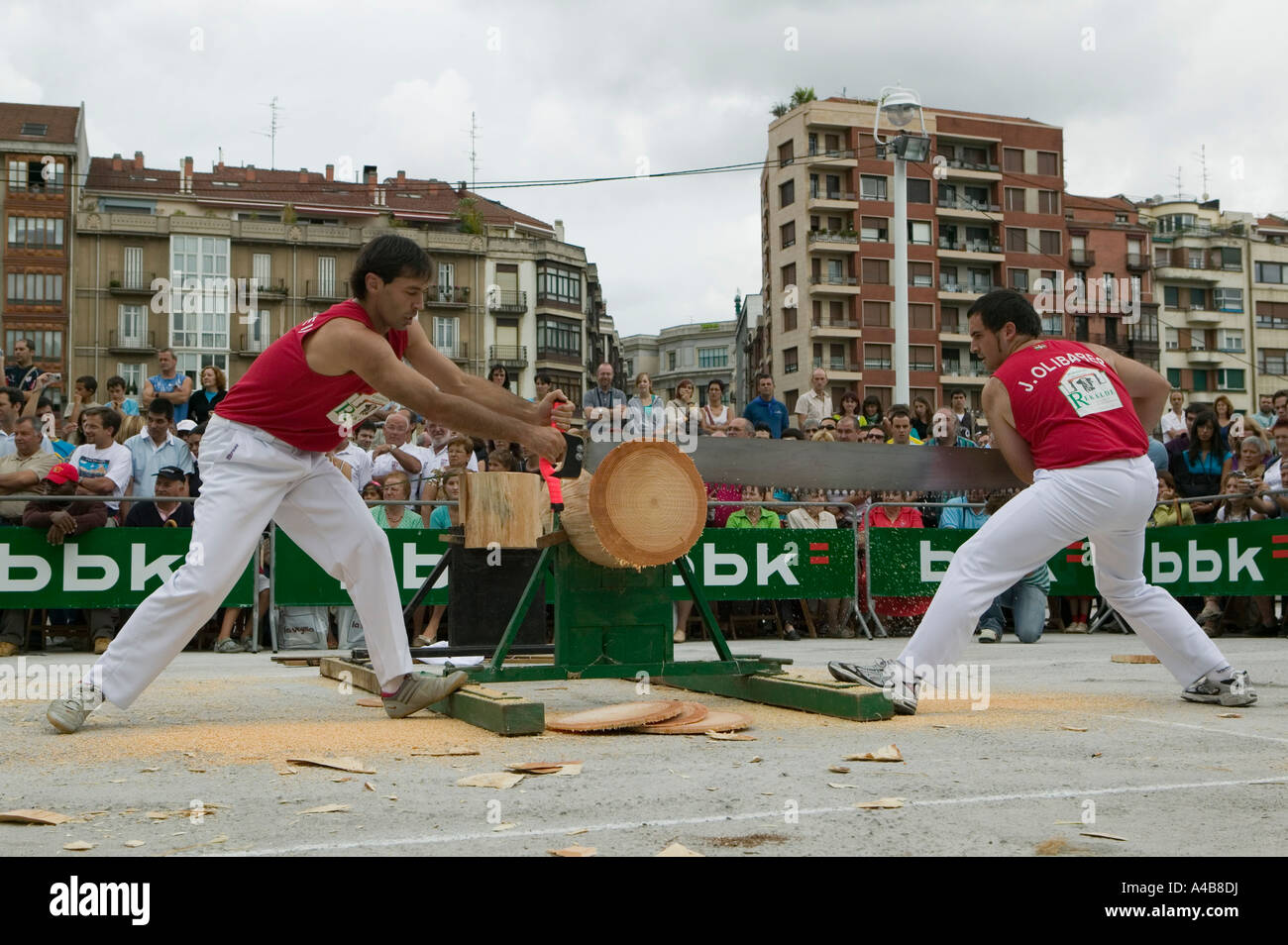 Two Basque men competing in trontzalaritza (log sawing) competition ...