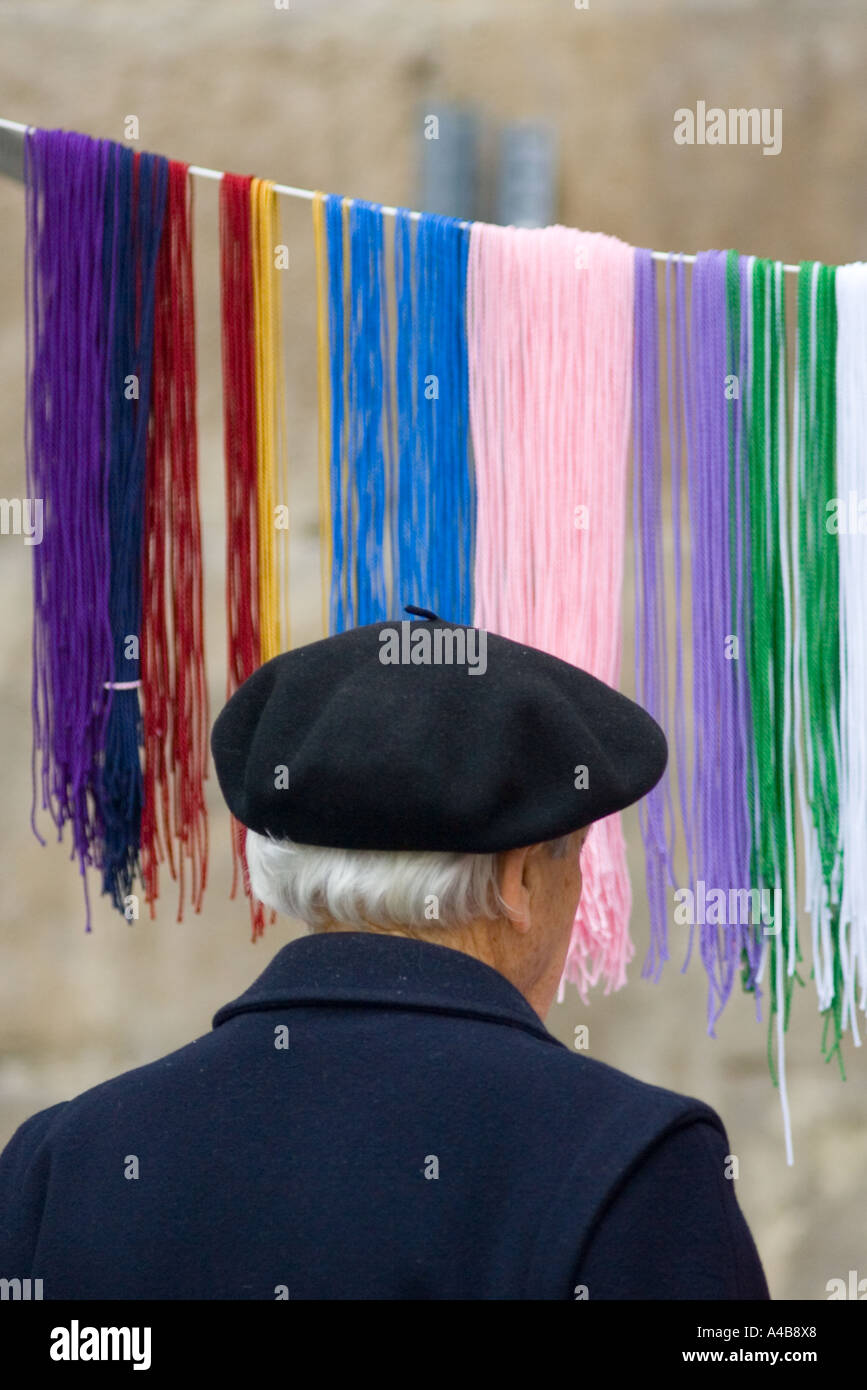 Rear view of a man with Basque beret in front of coloured chords for ...