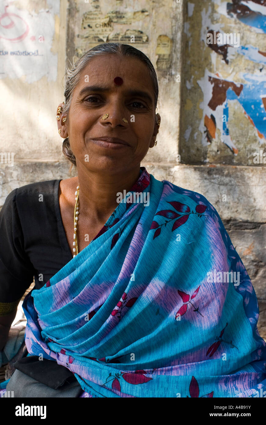 Stock image of a Hindu woman in a blue sari selling fruit in central ...