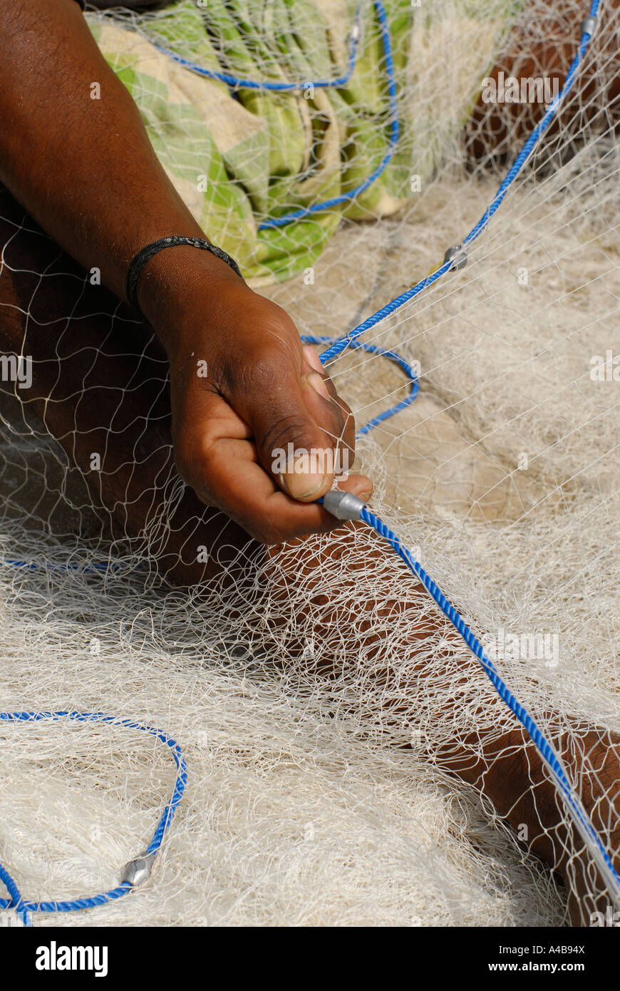 Stock image of Indian tribal fishermen fishers repairing their fishing ...
