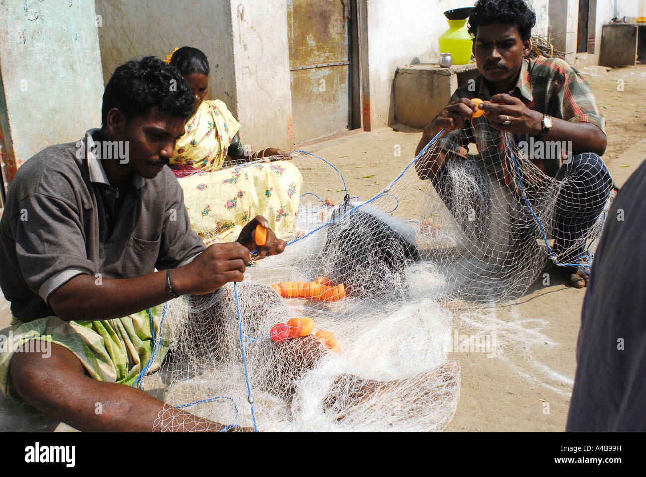 Woman mending fishing nets hi-res stock photography and images - Alamy