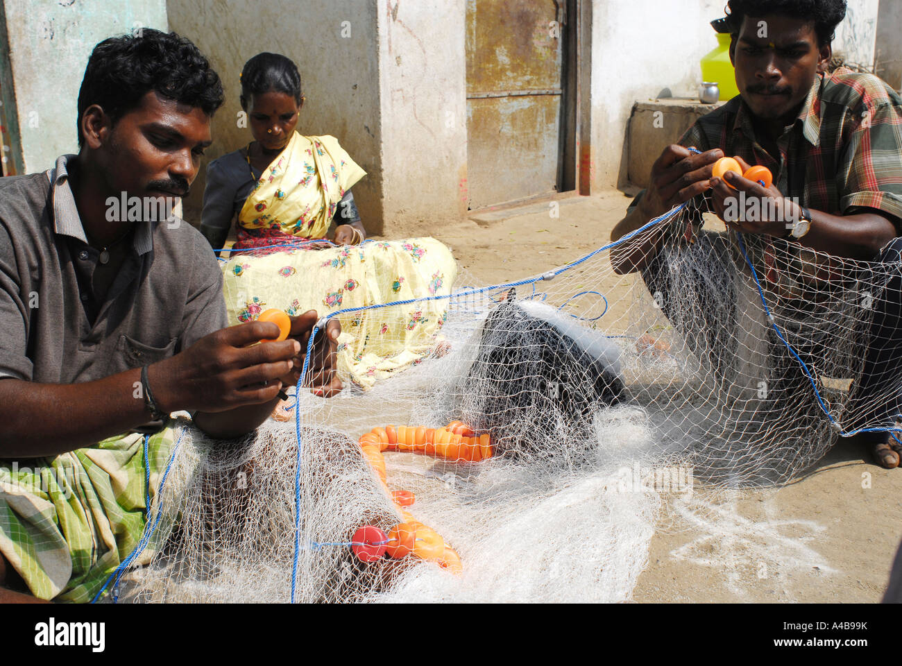 Woman mending fishing nets hi-res stock photography and images - Alamy