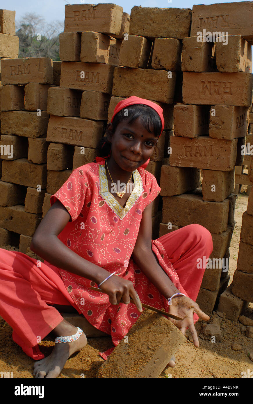 Stock image of Dalit tribal village girl working in an adobe brick ...