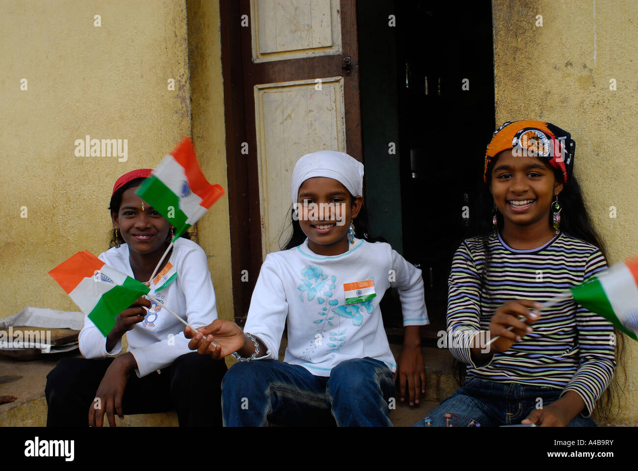 Three young Dalit girls waving Indian flags at Republic Day ...