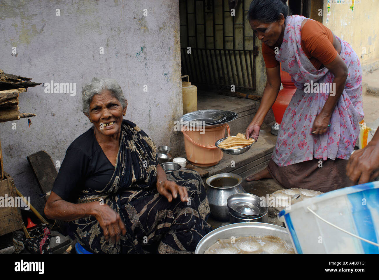 Stock Image of Dalit women eating outside in a Chennai slum Stock Photo ...