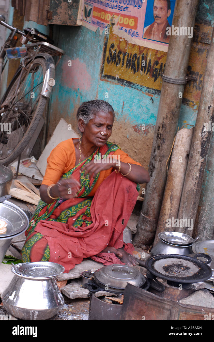 Stock image of old Dalit woman cooking outdoors in a Chennai slum Tamil ...