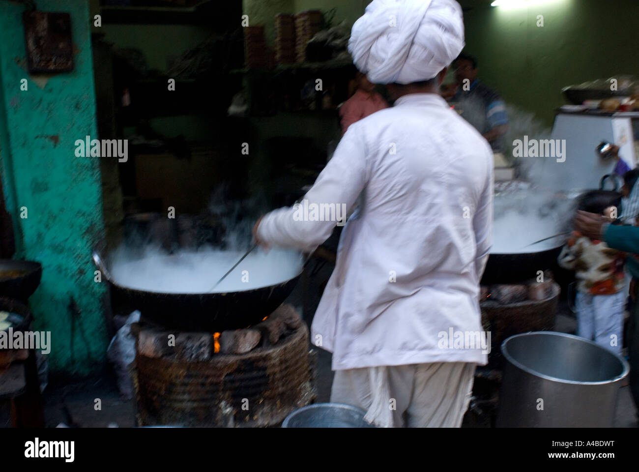 Stock image of Rajput chef in white turban cooking at night time in a ...