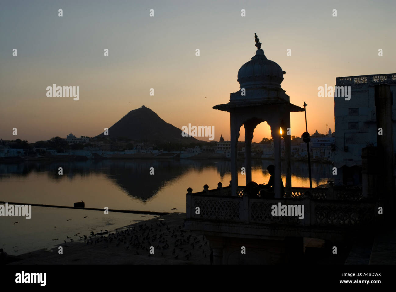 Stock image of Hindu Shrine or balcony silhouetted against Pushkar Lake ...