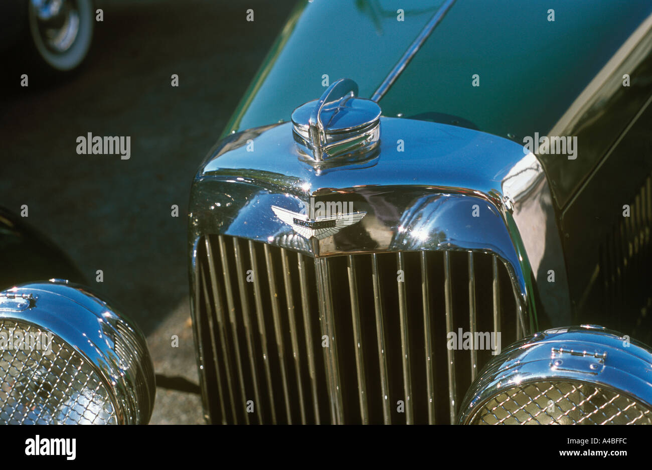 Aston Martin ensignia on classic car bonnet with radiator lamps grille ...