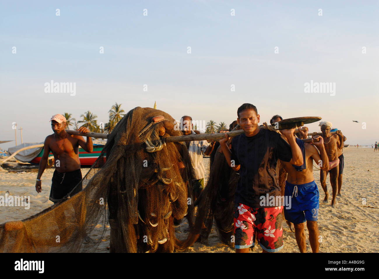 Stock image of Goan fishermen carrying their nets to a spot on the ...