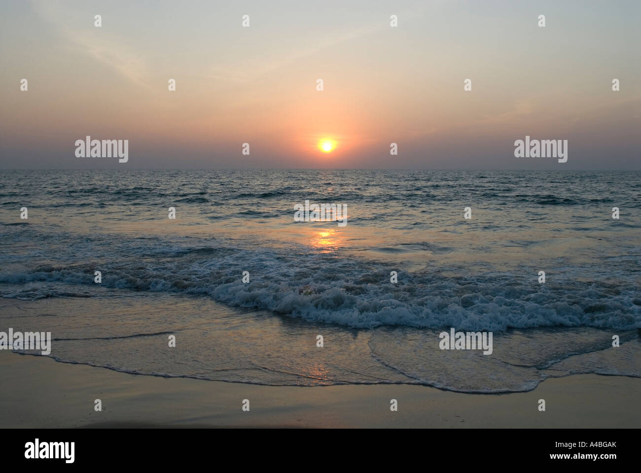 Stock image of waves lapping at shore in Goa India at sunset Stock ...