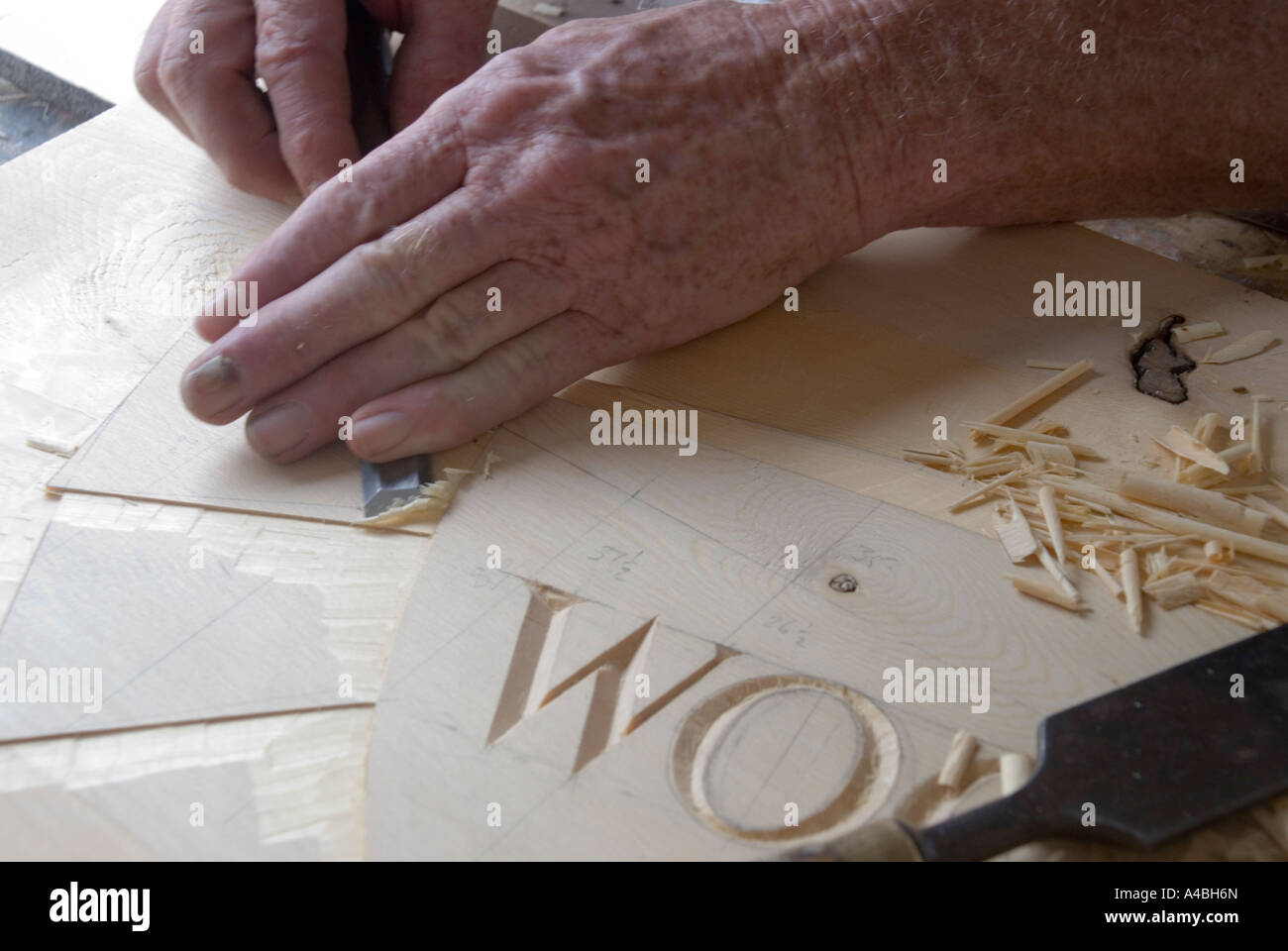A wood carver carving a wooden plaque at the Australian Wooden Boat ...