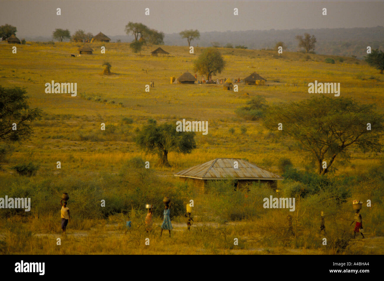 Daily life as women walk to a stream to fetch water and wash their pots ...