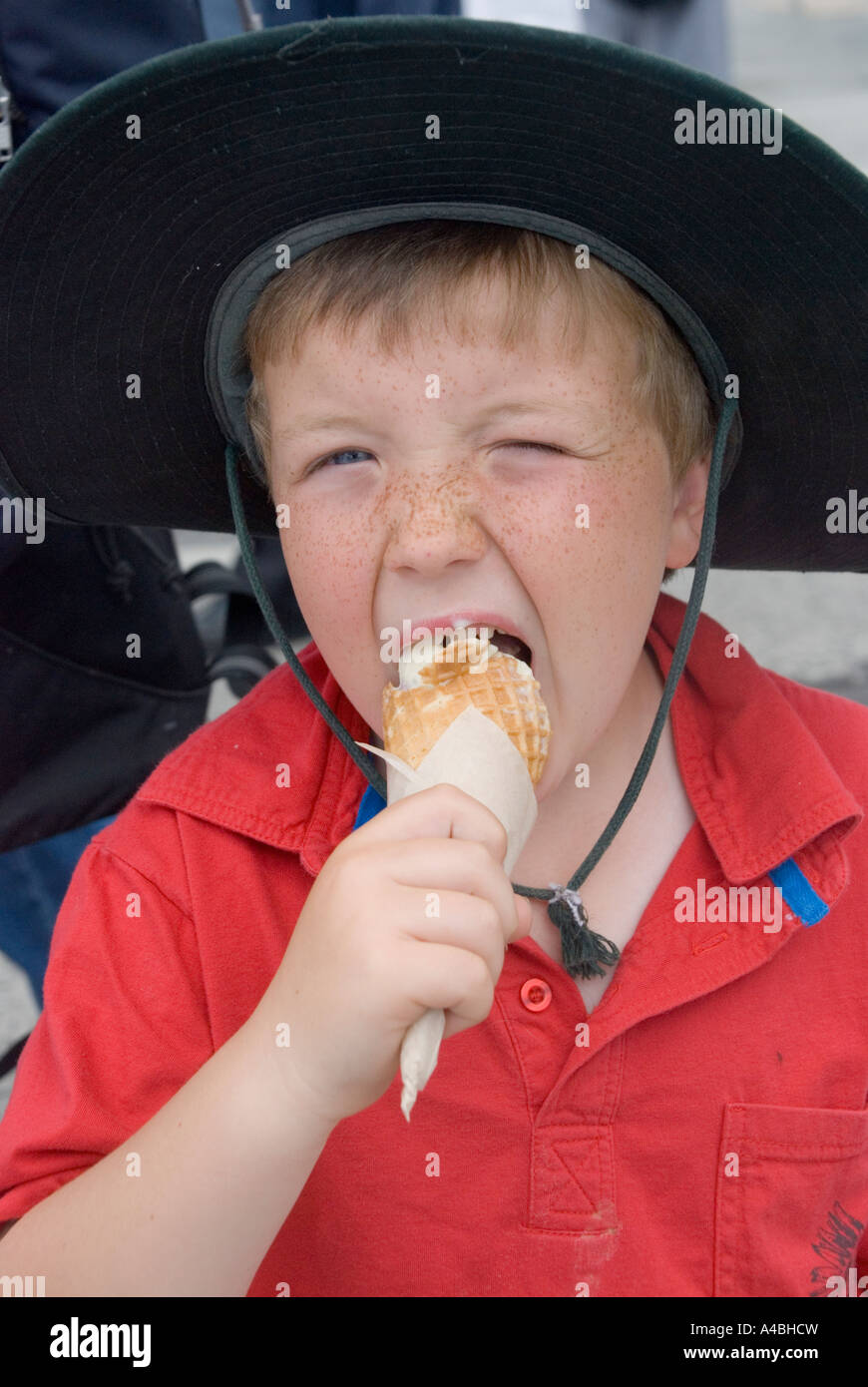 Young freckle faced boy eating and ice cream Stock Photo - Alamy