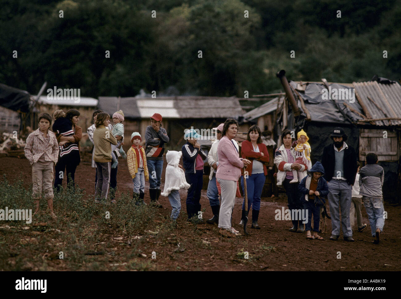 Landless peasants at a land invasion at wait for their armed leaders to ...