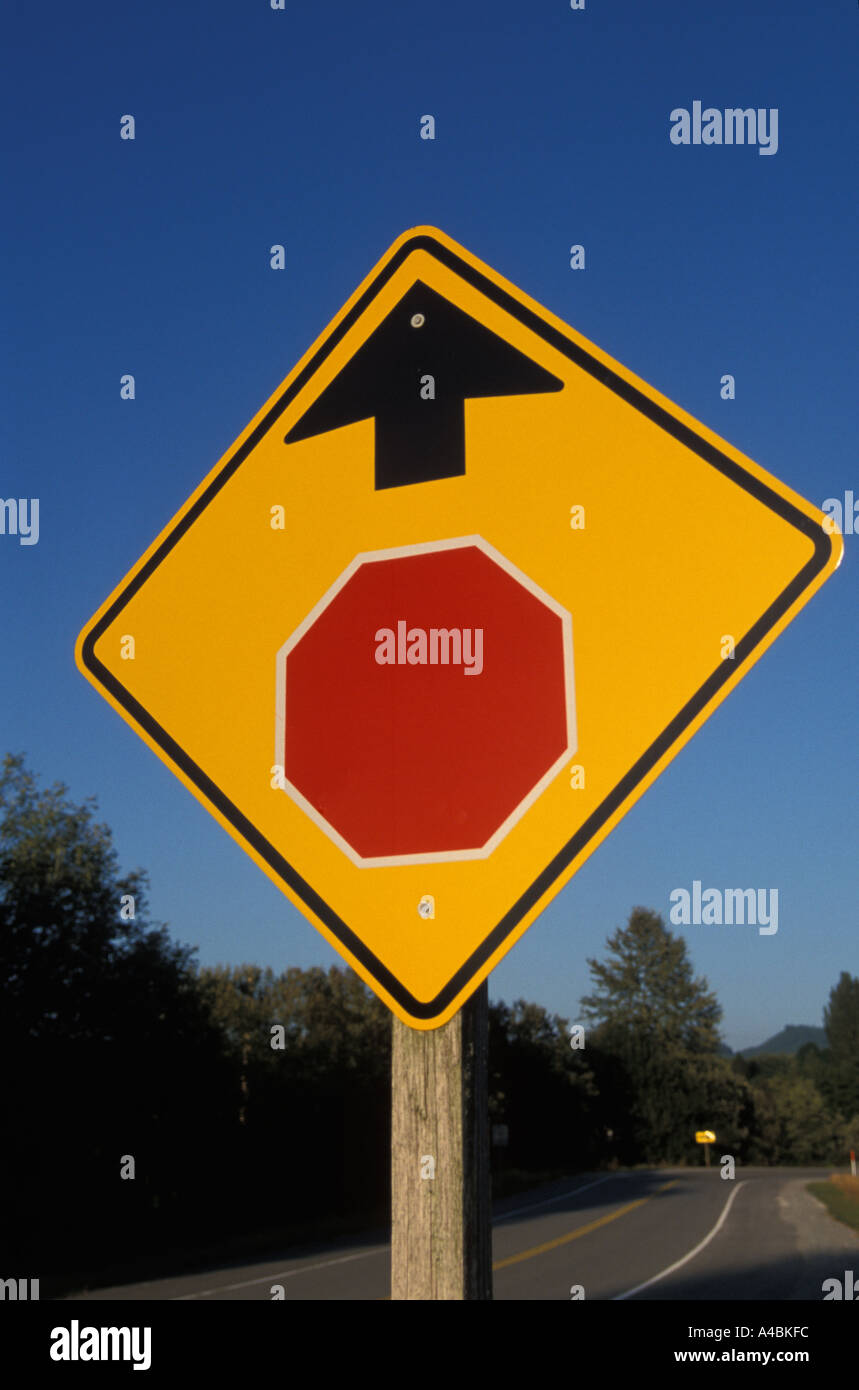 Stop sign warning on a highway intersection Stock Photo - Alamy