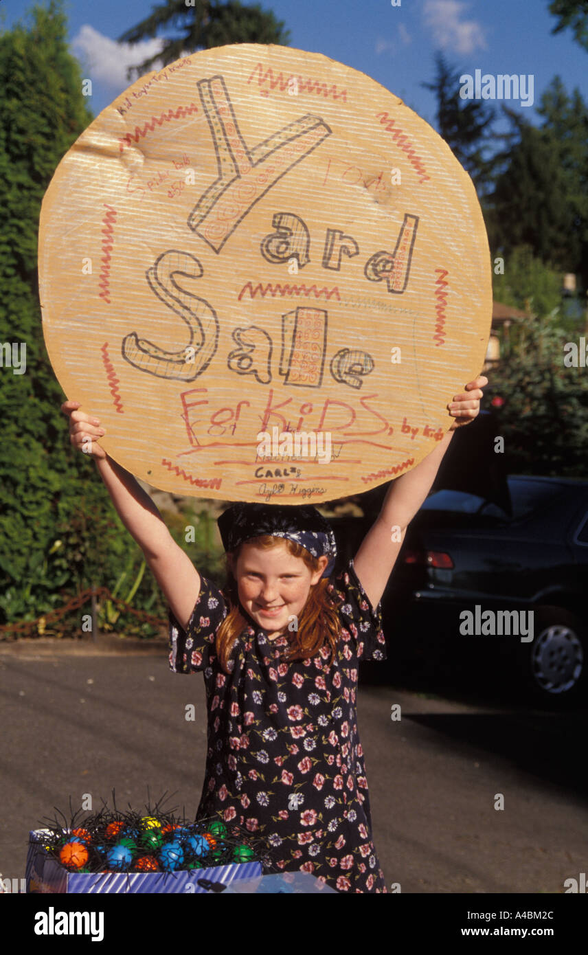 Young girl holding yard sale sign Stock Photo - Alamy