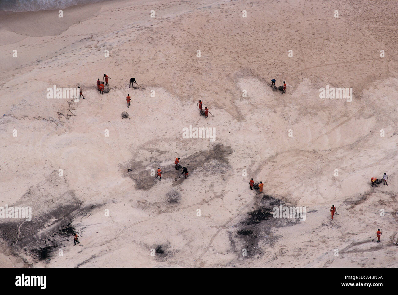 Conrado Beach, Rio De Janero; council workers clean up effluent from a ...