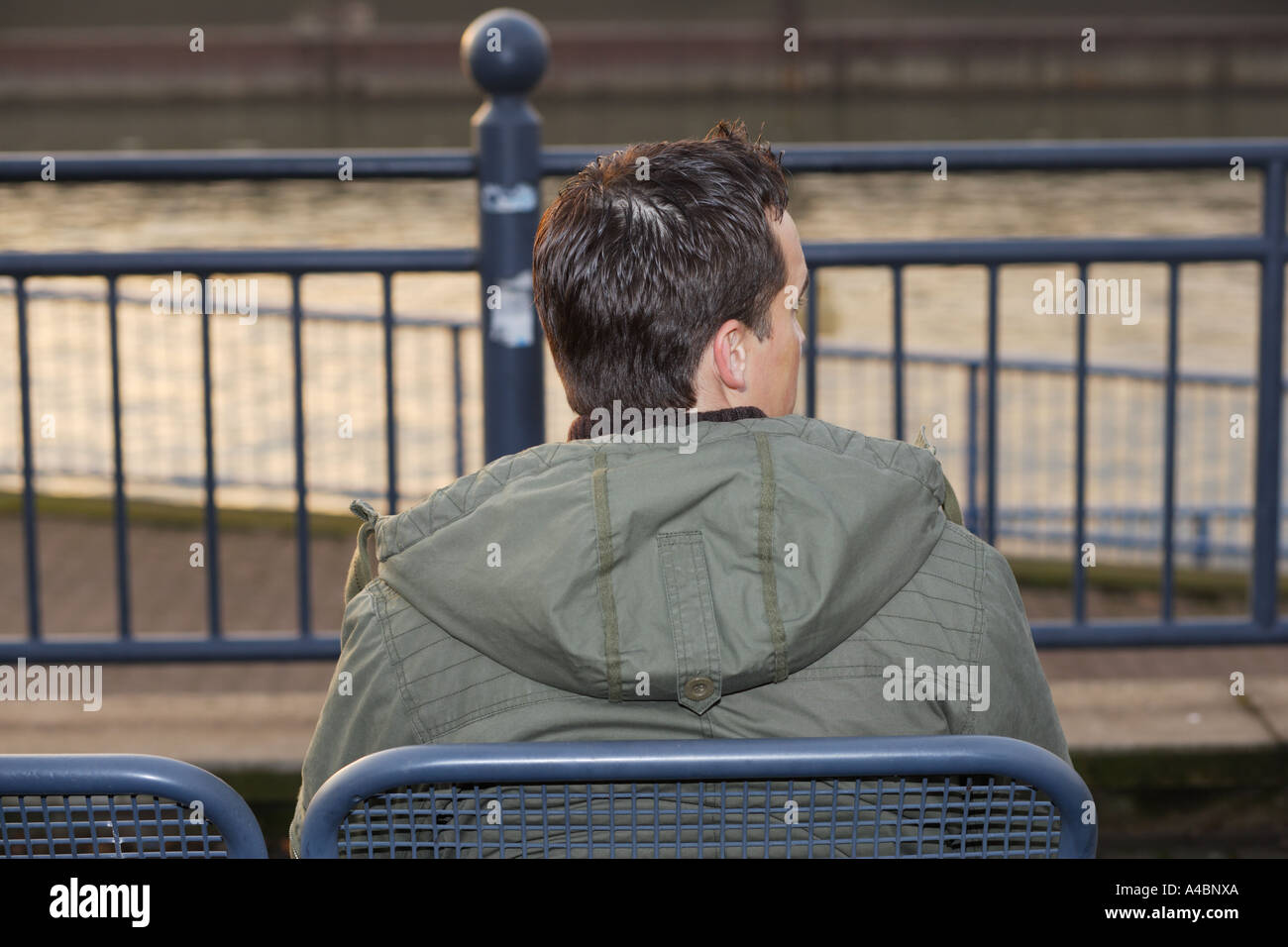 Young man sitting waiting hi-res stock photography and images - Alamy