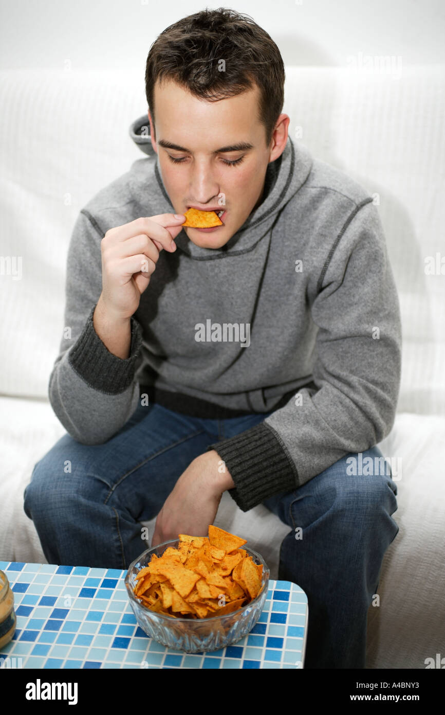 Young man eating potato chip hi-res stock photography and images - Alamy