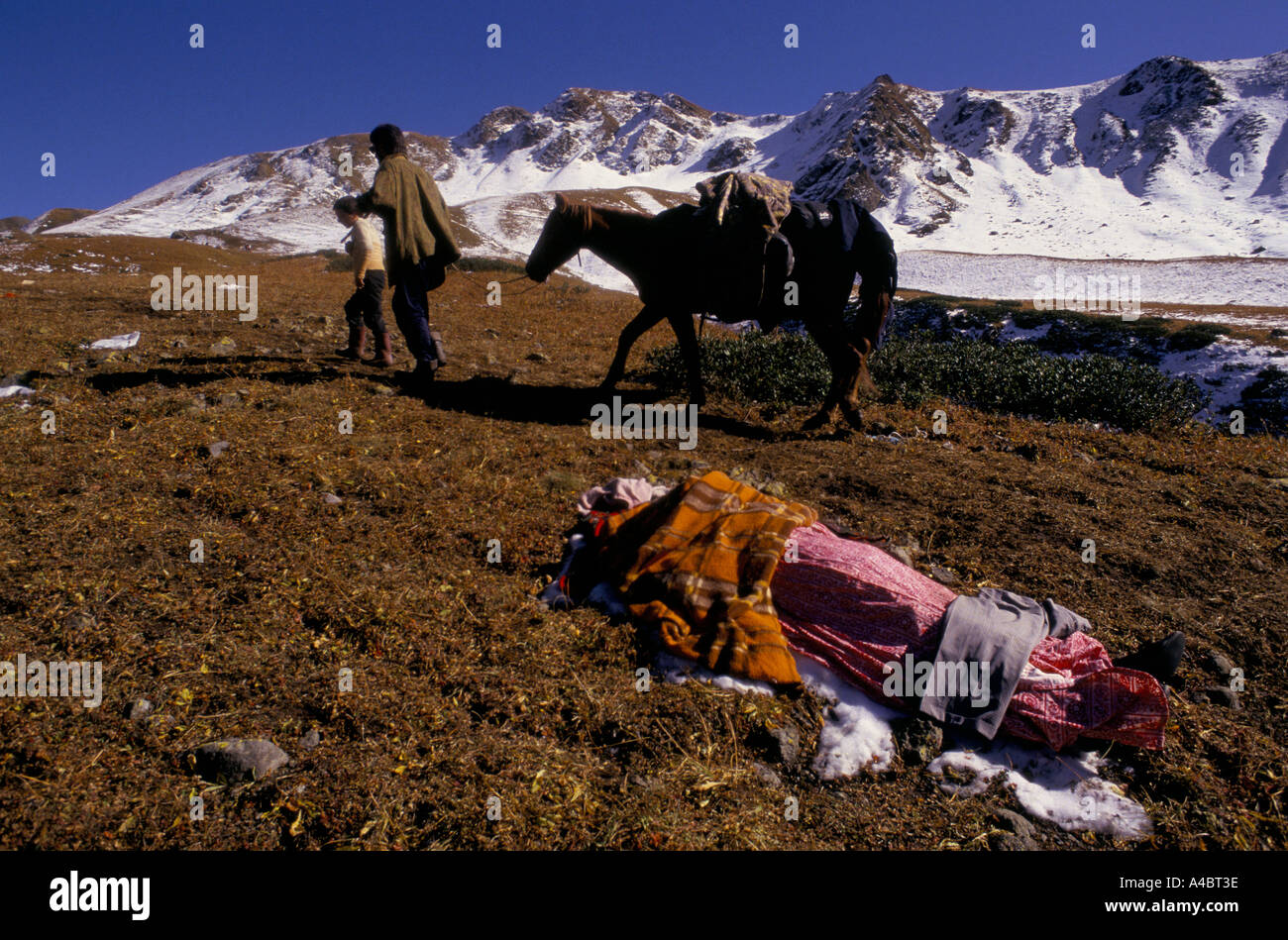 CHUBERI PASS, GEORGIA, OCTOBER 1993: Refugees walking with a pack horse ...
