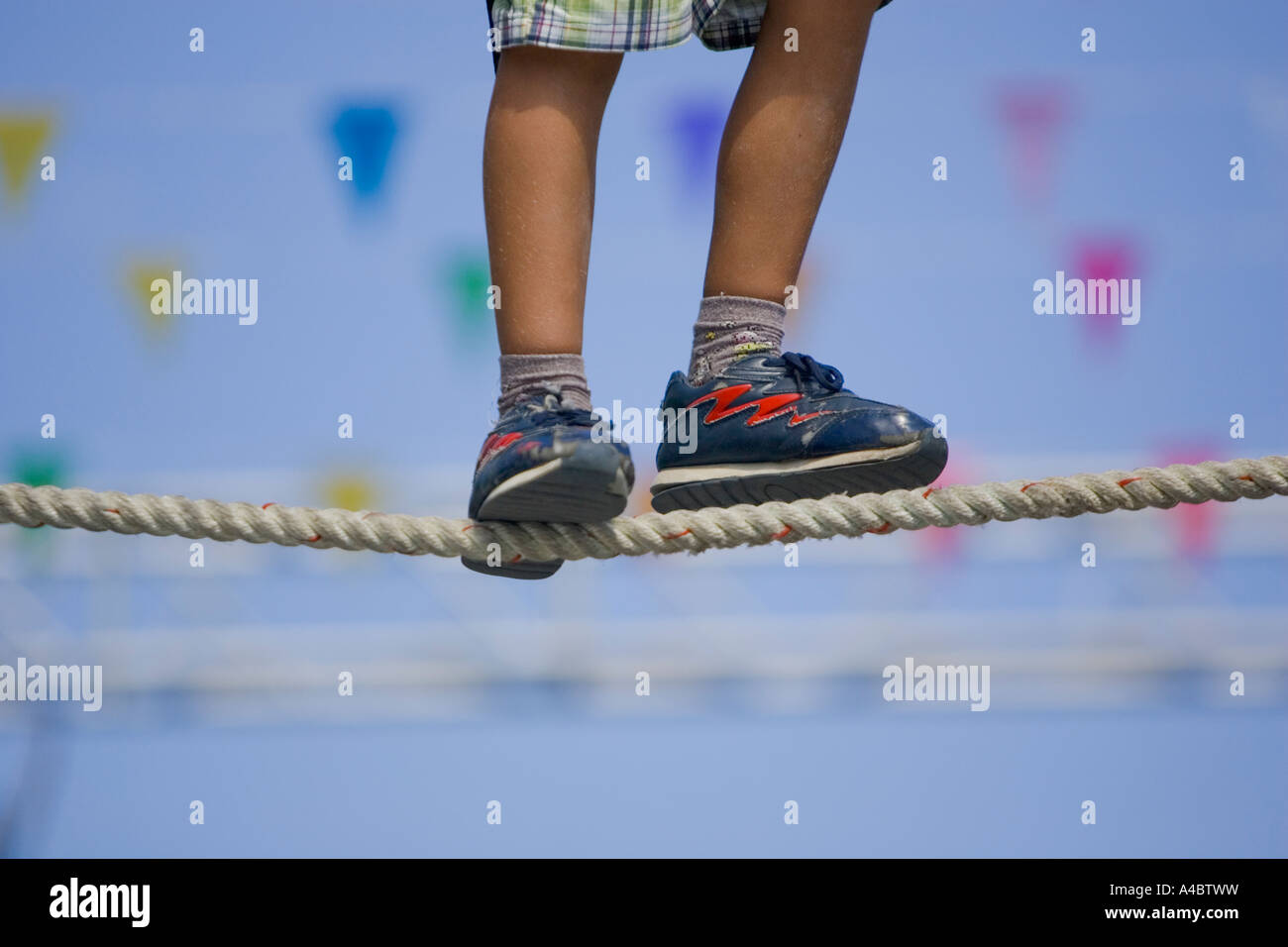 Legs and feet of young child balancing on tightrope, Bilbao, Basque ...