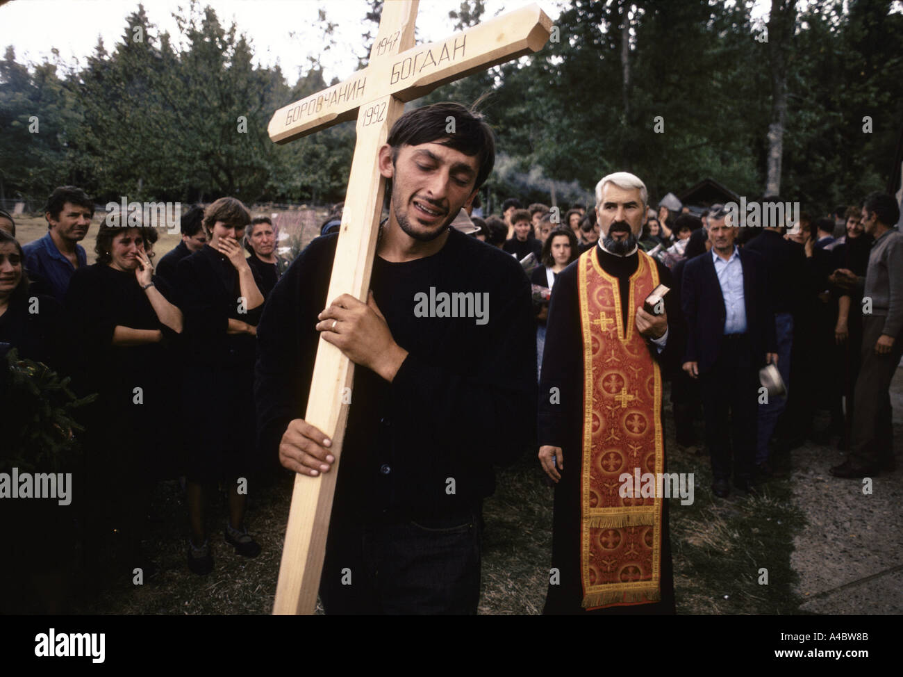 Serbian women grieving are comforted by other family members beside the ...