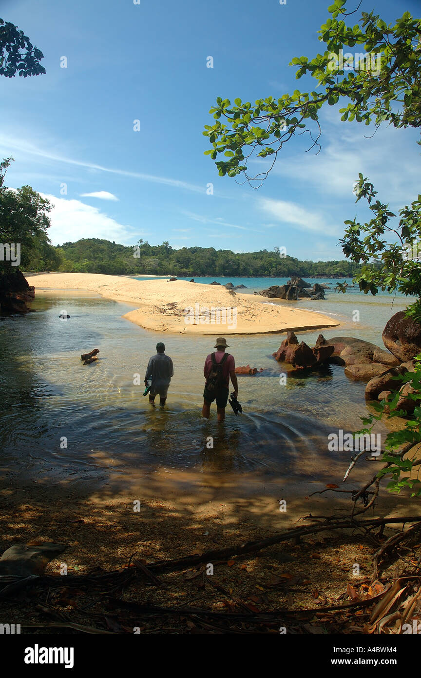 Hikers crossing the mouth of a river in Tampolo Marine Reserve Stock ...