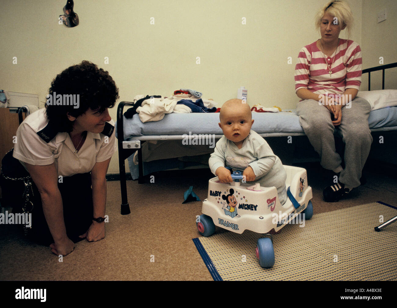 An inmate spends time with her baby son under the watch of a prison officer Stock Photo - Alamy