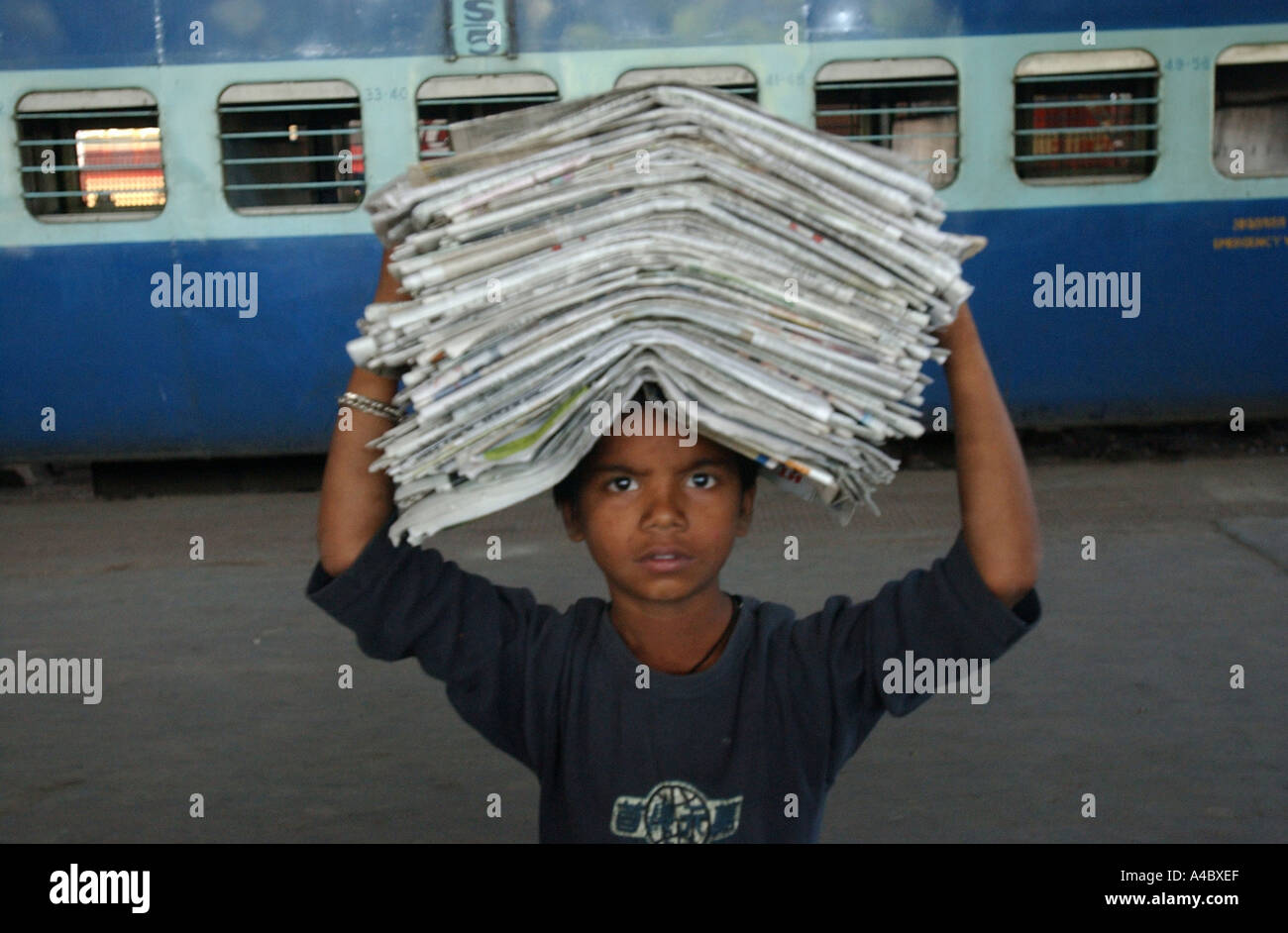 Indian street children collecting newspapers left behind by train ...