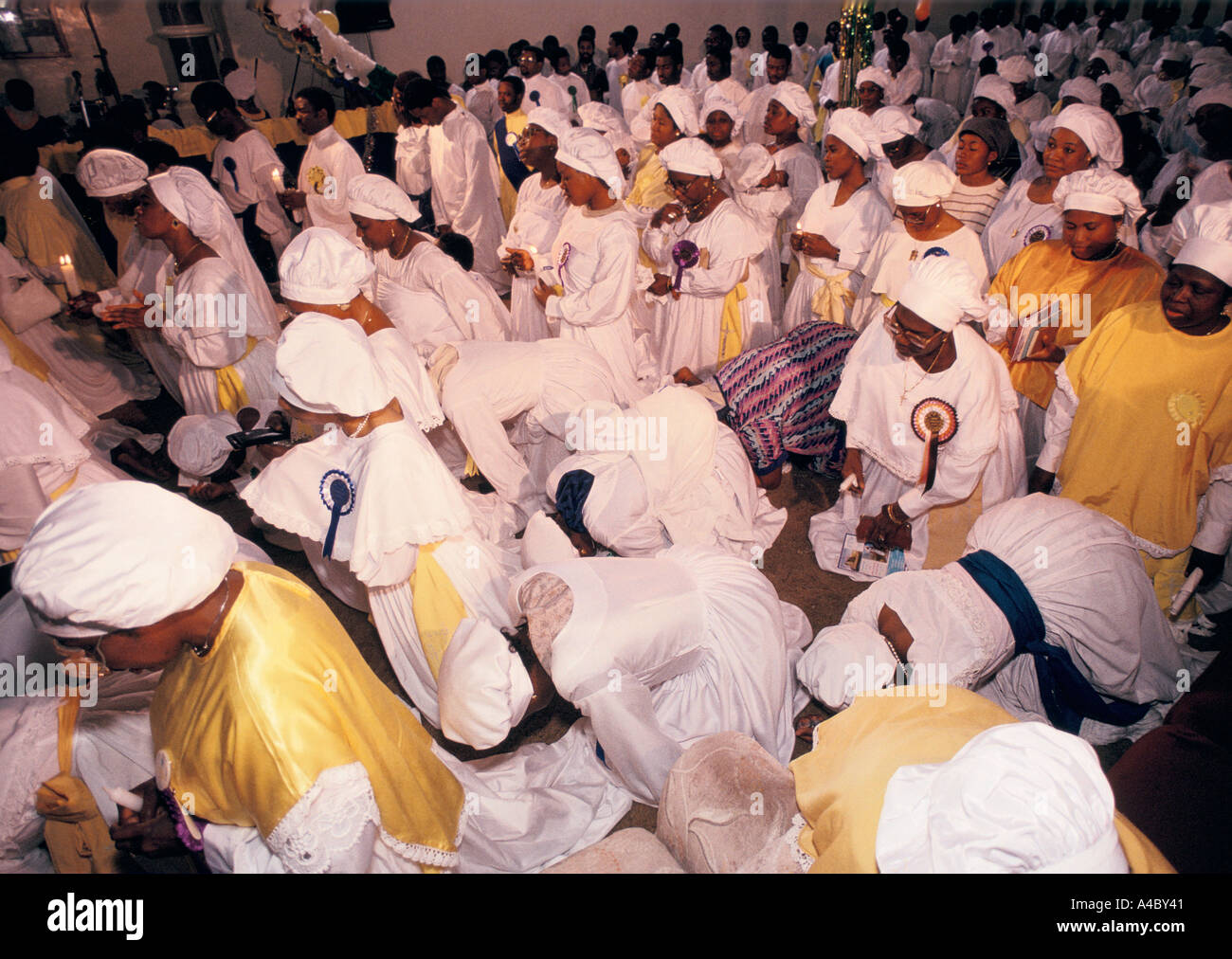 Members of the Celestial Church Of Christ pray during the harvest ...