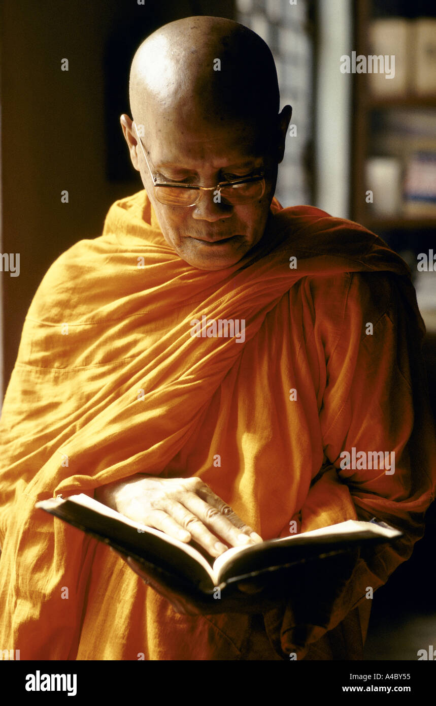 A Buddhist priest reads religious literature in Phnom Penh. These books ...