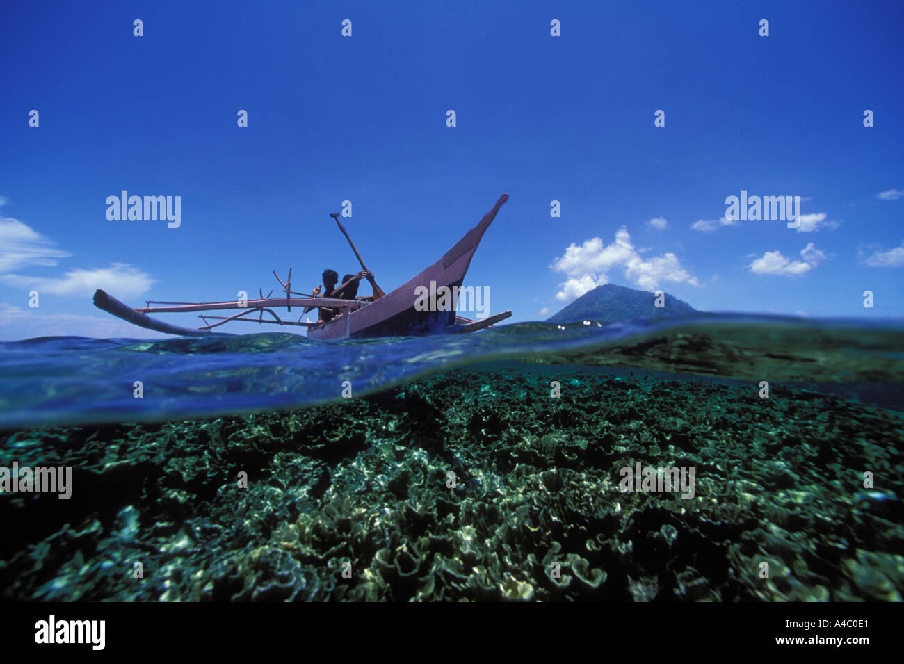NATIVE FISHERMAN IN MANADO INDONESIA WITH REEF SHOWN BELOW WATER Stock ...