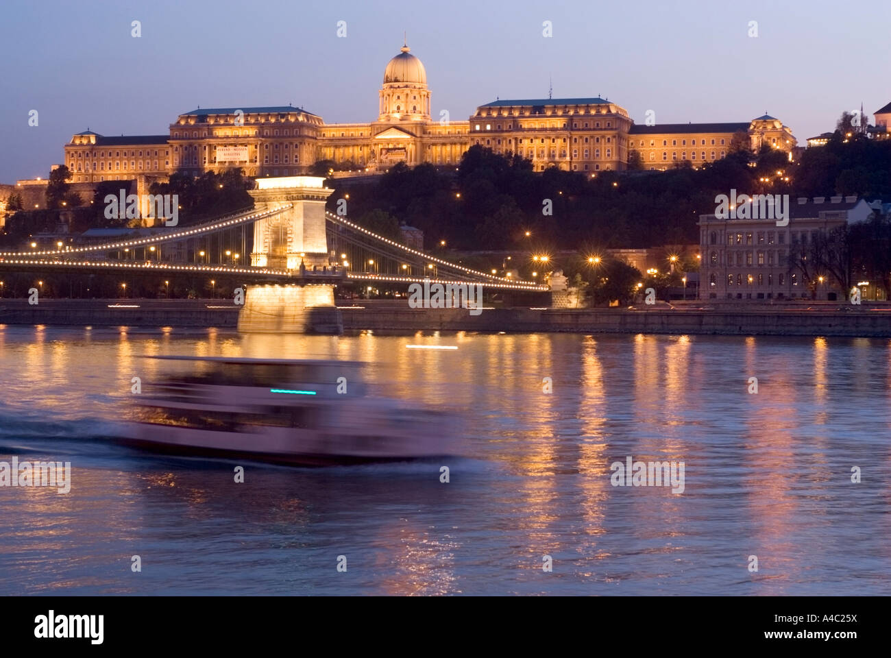 Chain Bridge and Buda Castle at dusk with Boat Budapest Hungary Stock ...