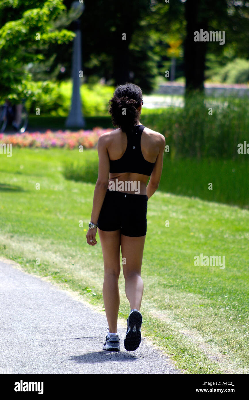 Woman walking along bike path Stock Photo - Alamy