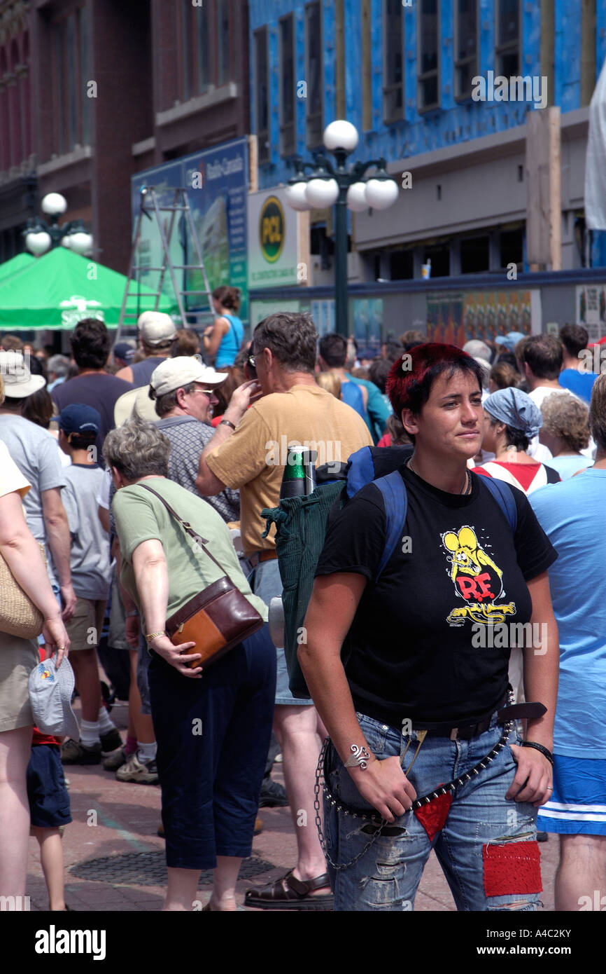 A busker leaving while the crowd is entertained by another artist on ...