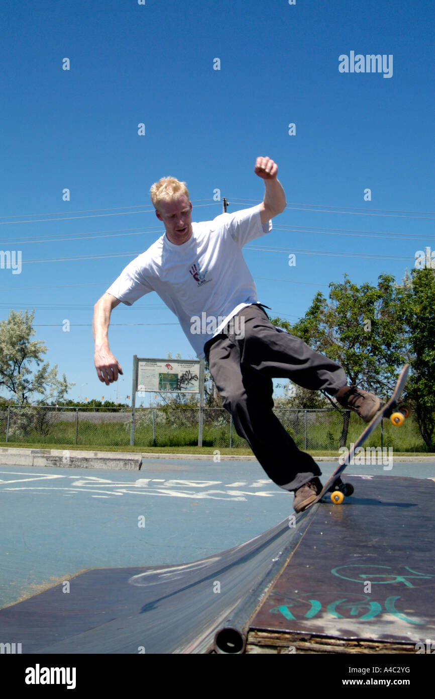Skateboarder on top of ramp Stock Photo - Alamy