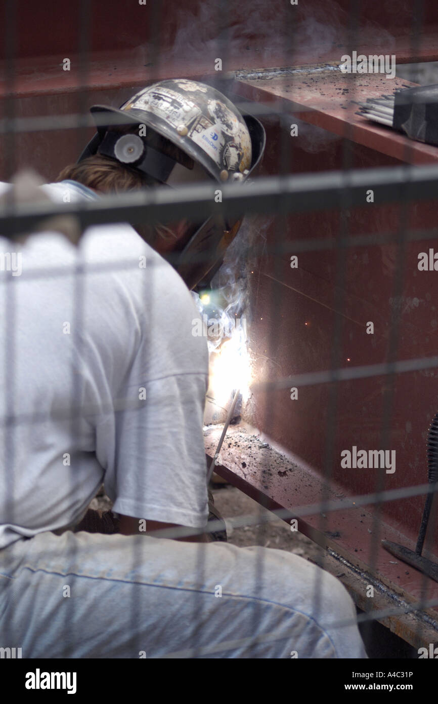 Welder welding metal beams Stock Photo - Alamy