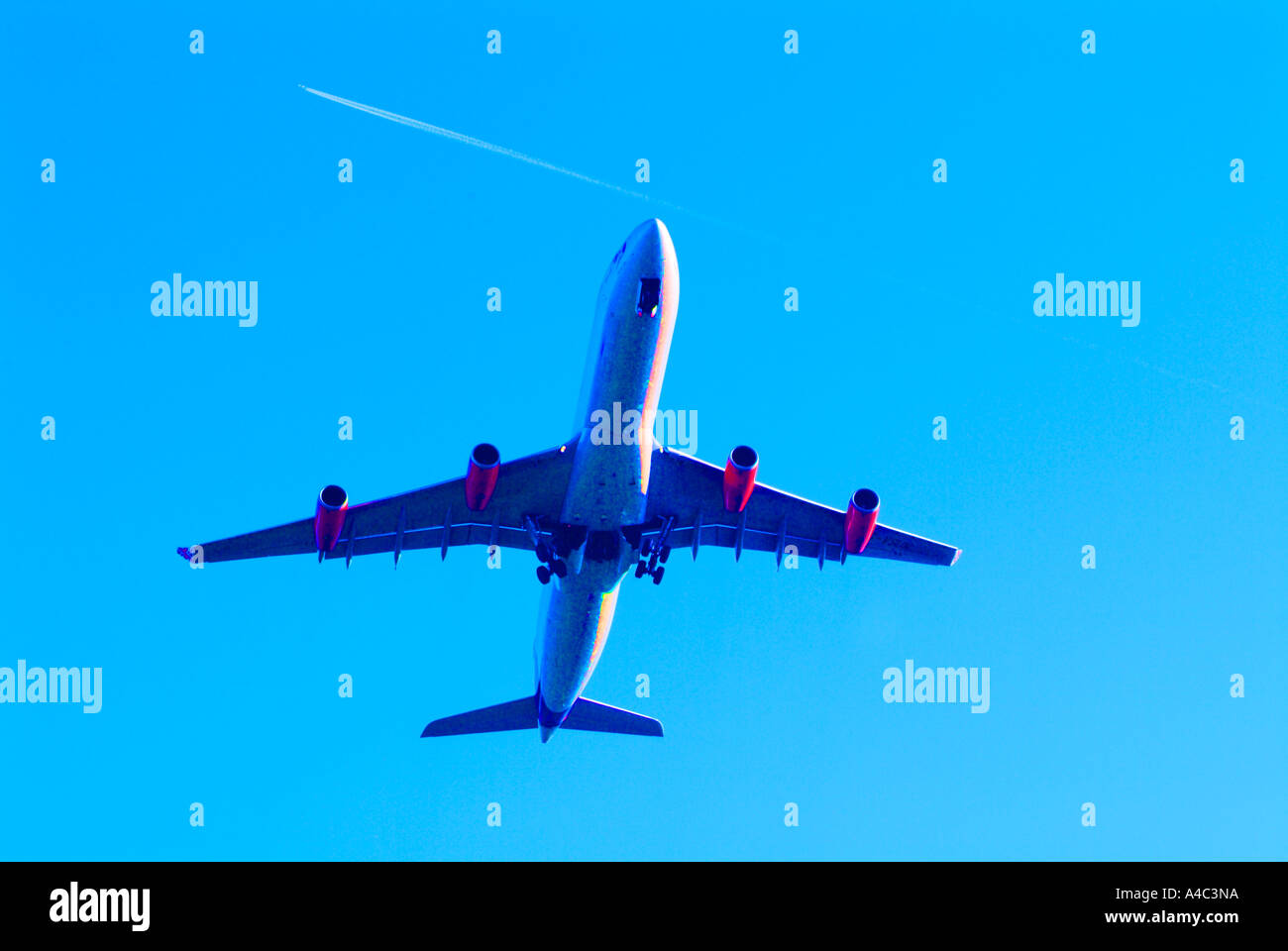 Aeroplane flying with another plane con trail above it Nottingham East ...