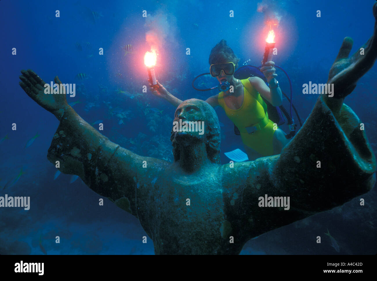 A FEMALE SCUBA DIVER AT THE STATUE OF CHRIST OF THE ABYSS IN KEY LARGO ...