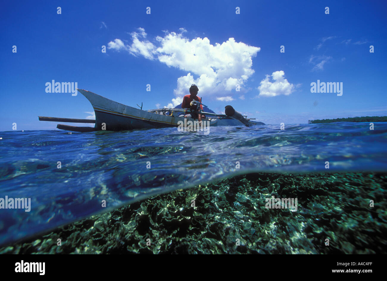 NATIVE FISHERMAN ABOVE A CORAL REEF IN INDONESIA Stock Photo - Alamy
