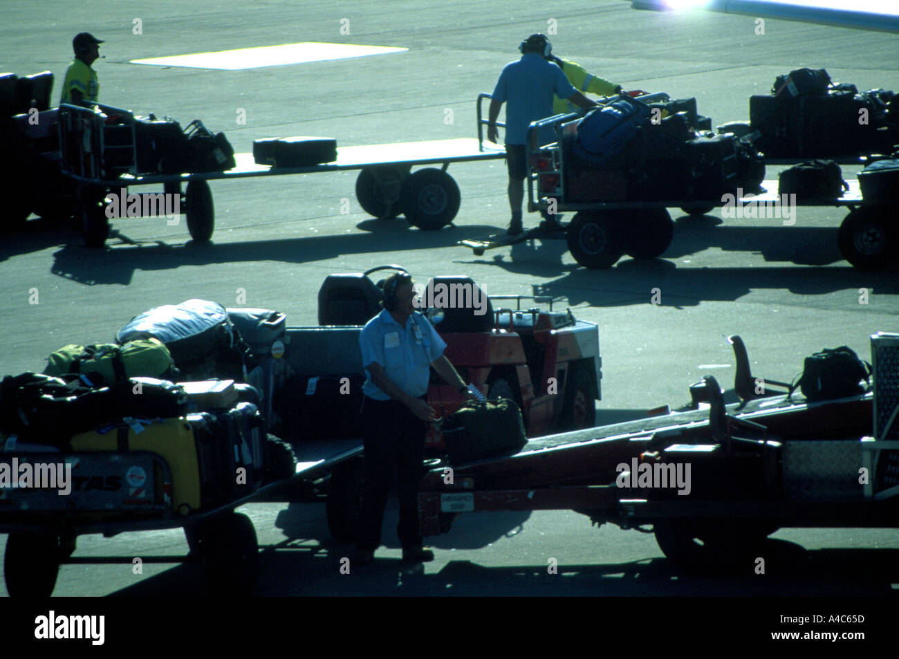 Airport staff loading suitcases airport hi-res stock photography and ...