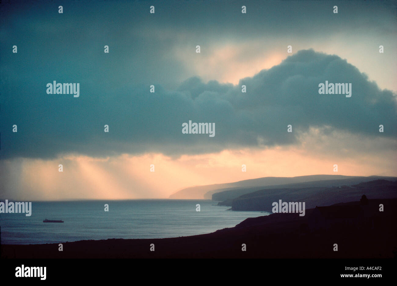 Dramatic sky over coastal seascape with sheltering vessel at Berriedale ...