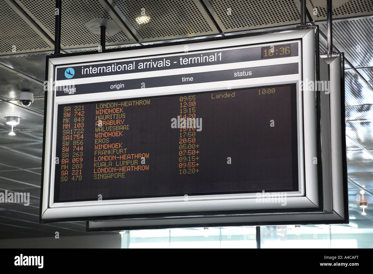 international arrivals board at airport Stock Photo - Alamy