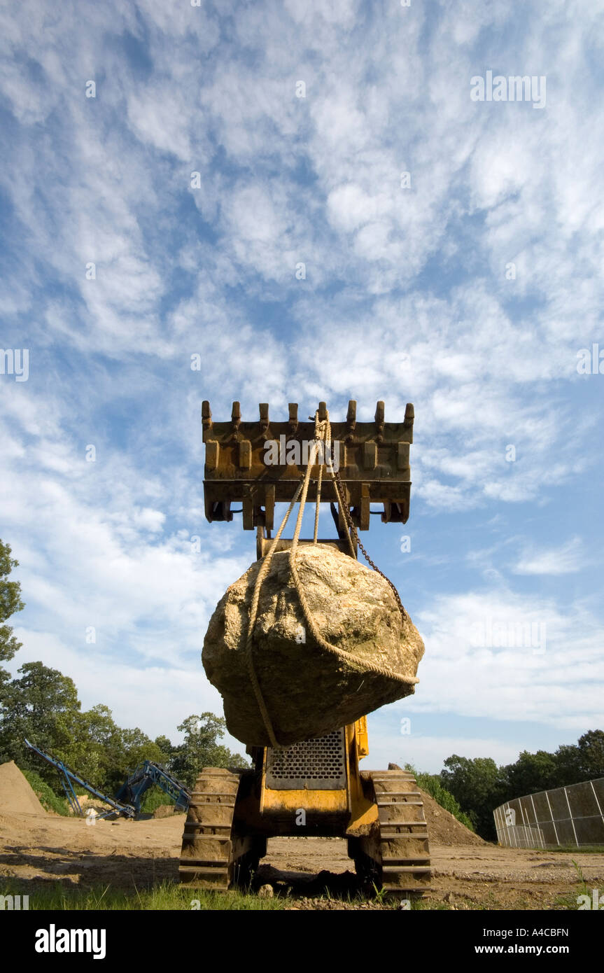 Crawler-loader lifting a boulder. Full description below Stock Photo ...