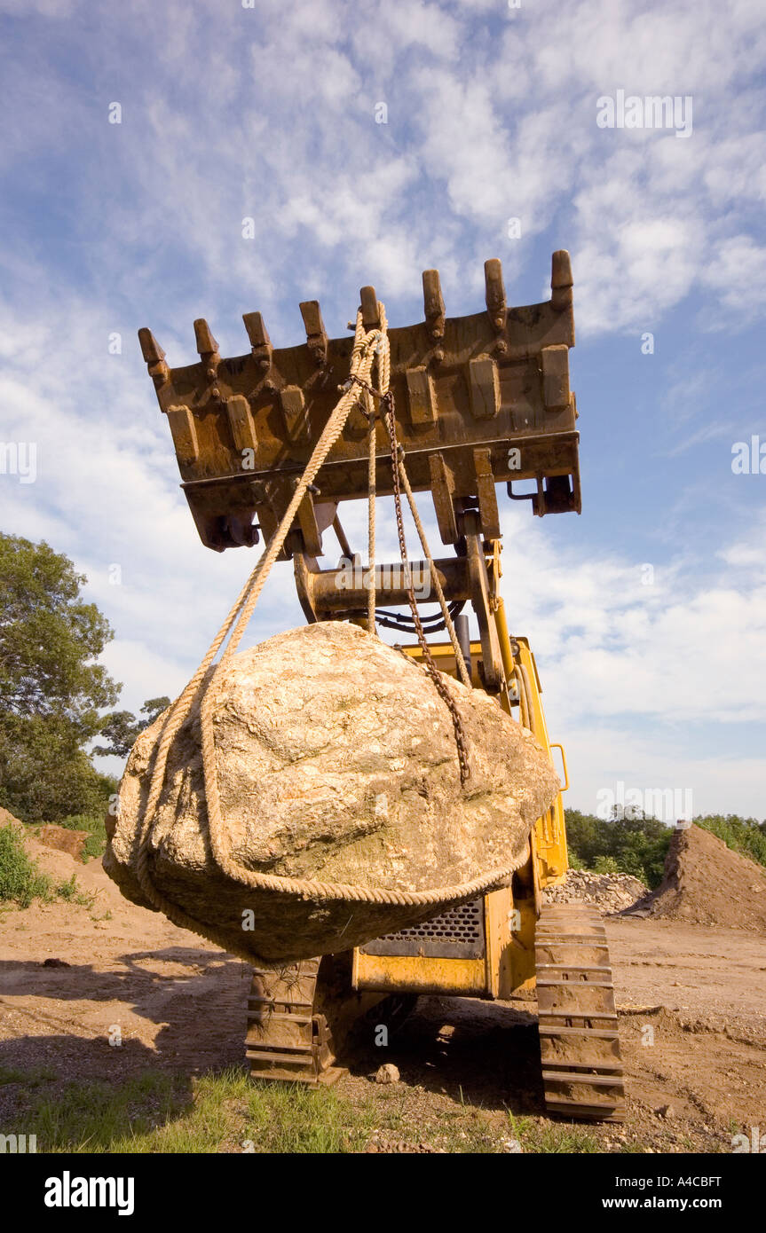 Crawler-loader lifting a boulder. Full description below Stock Photo ...