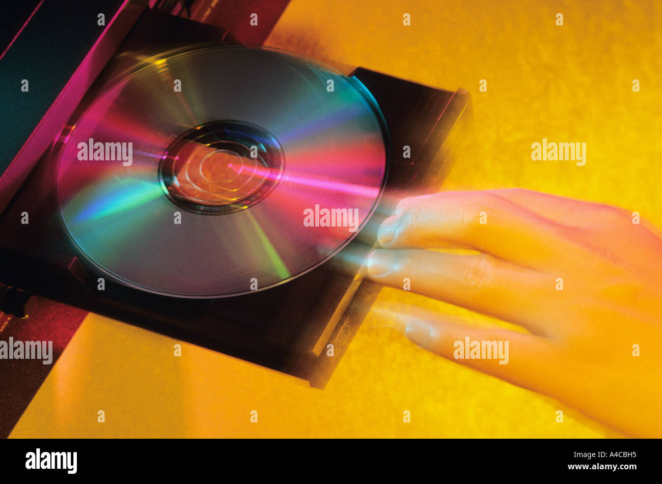 Hand pushing CD into a platter Stock Photo - Alamy