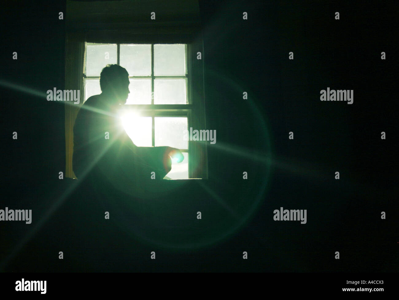 Man sitting window looking waiting sunlight hi-res stock photography ...